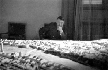 Hitler looking at a model of the ’new’ Linz in München, April 1943.